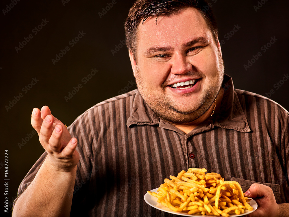 Foto de Diet failure of fat man eating fast food. Overweight person who ...
