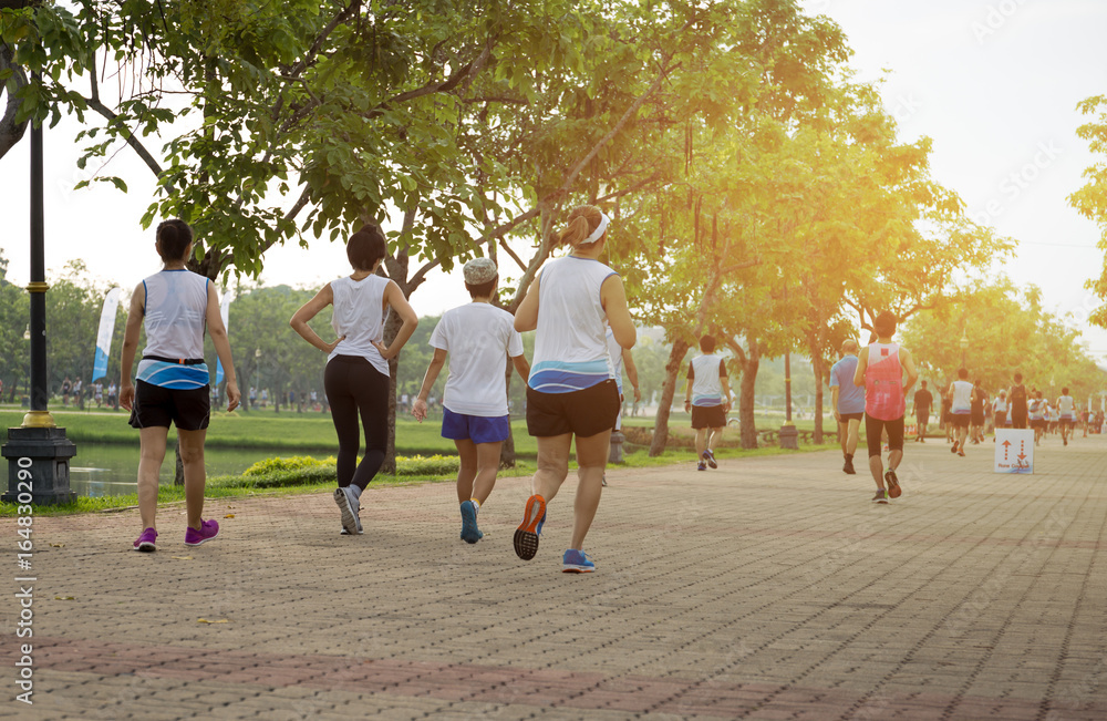 Group of people running marathon in the park Stock Photo | Adobe Stock