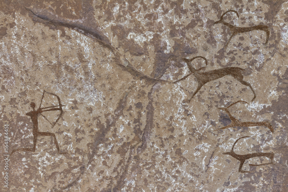 Image drawing of ancient man in ocher on the cave wall, rock ...