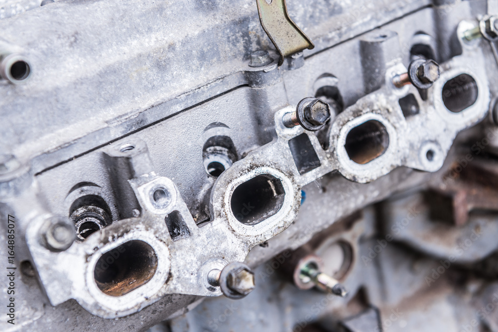 Exhaust gas exit ports on an old engine block with the exhaust manifold ...