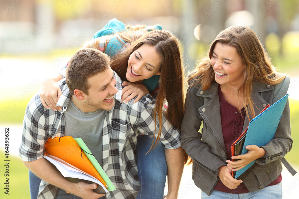 Happy students and friends in a campus Stock Photo | Adobe Stock