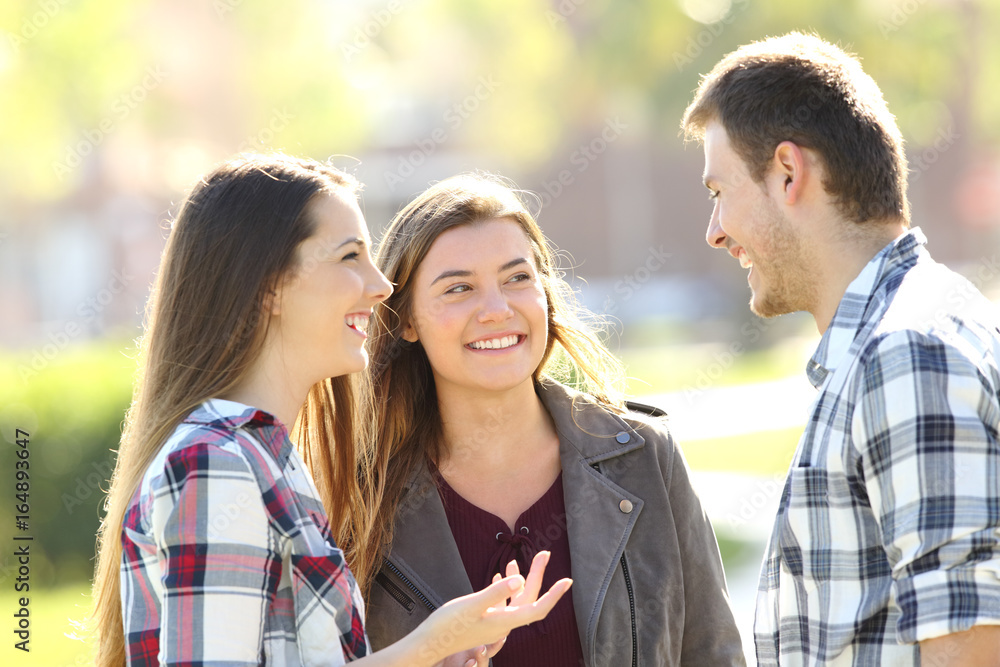 Three happy friends talking in the street Stock Photo | Adobe Stock