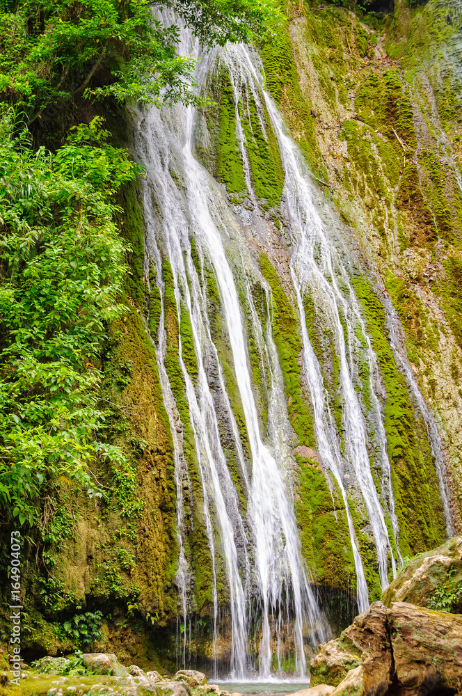 Part of the 35m tall upper section of the Mele Cascades Waterfalls ...