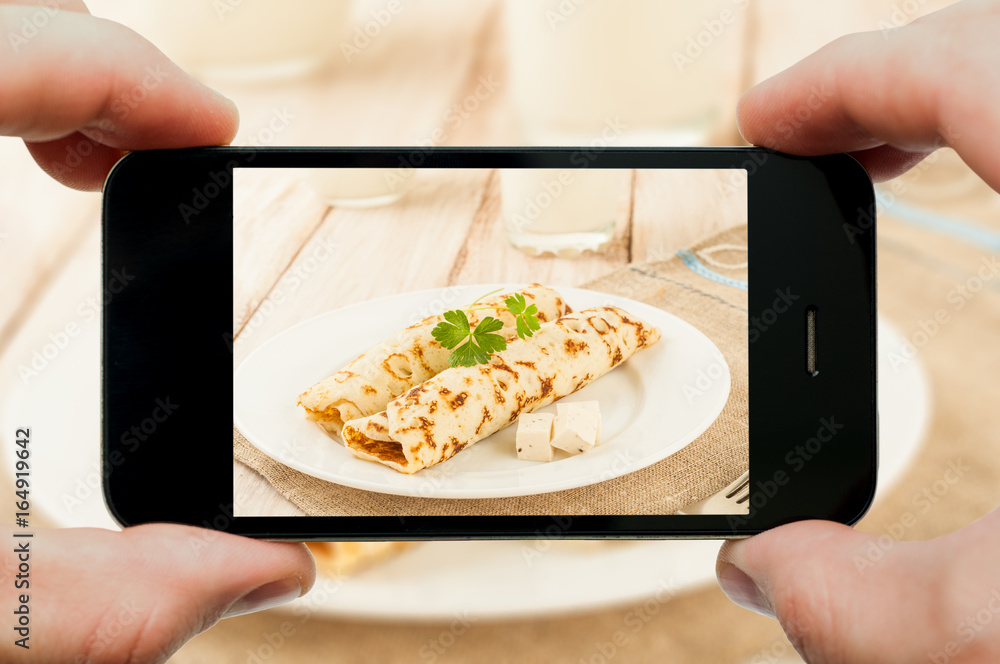 Taking photo of pancake by smartphone. Closeup view of process. File ...