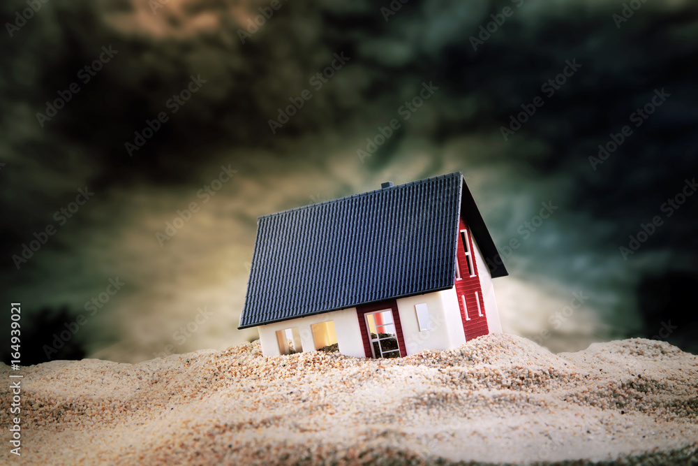 Small model of house in sand Stock Photo | Adobe Stock