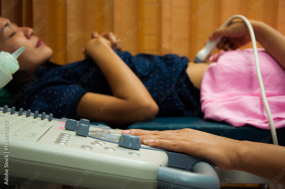 Medicine doctor working with ultrasound machine scan abdomen of patient ...