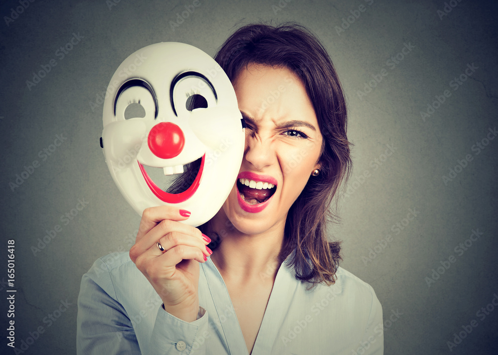 angry screaming woman taking off happy clown mask Stock Photo | Adobe Stock