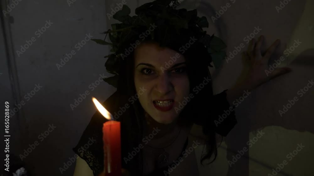 Exorcism of witch with evil sneer possessed by demon dressed in black ...