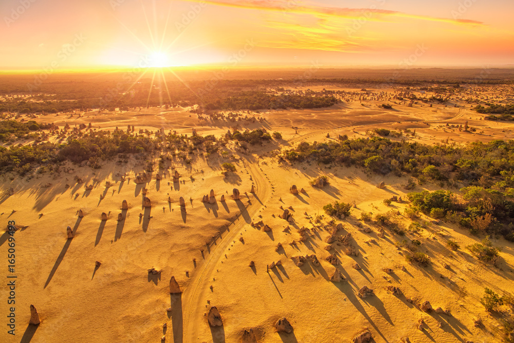 Aerial view of the sun setting over the Pinnacles Desert, Western ...