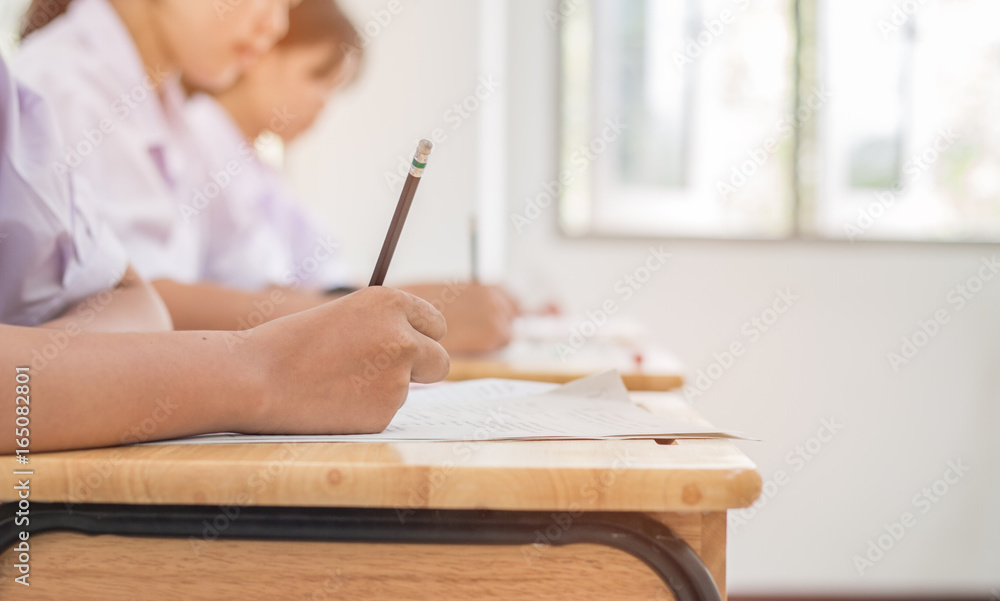 Asian girls students writing test exams on paper for Admissions in high ...