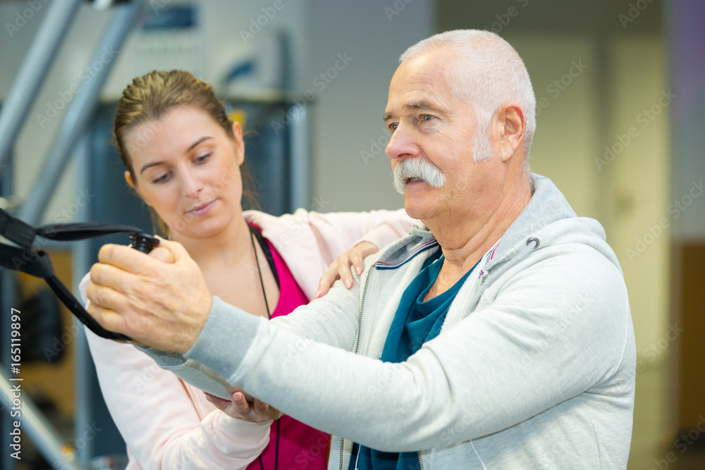 sports coach guiding senior man Stock Photo | Adobe Stock