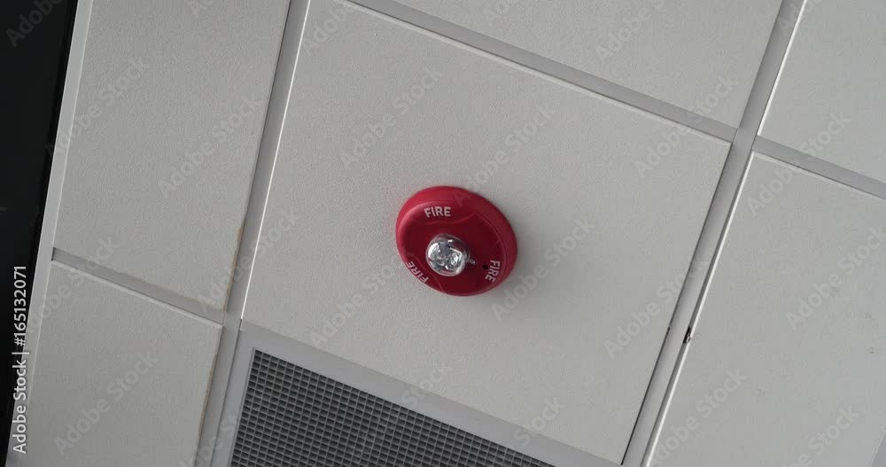A close up shot of a fire alarm warning light on the ceiling of an ...