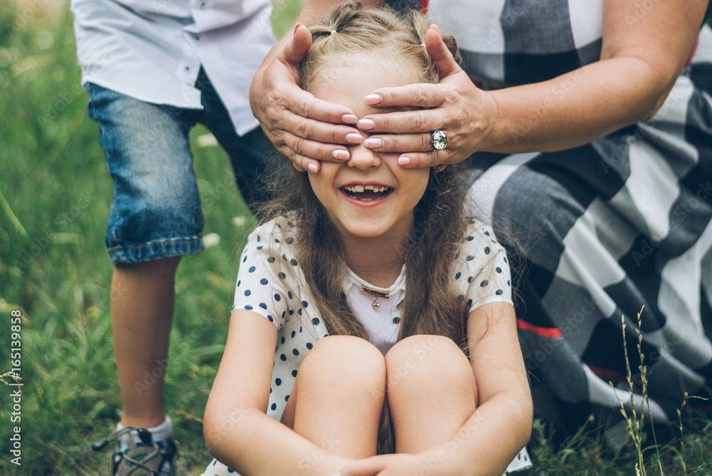 kids playing in the park, guess who, closing each other eye Stock Photo ...