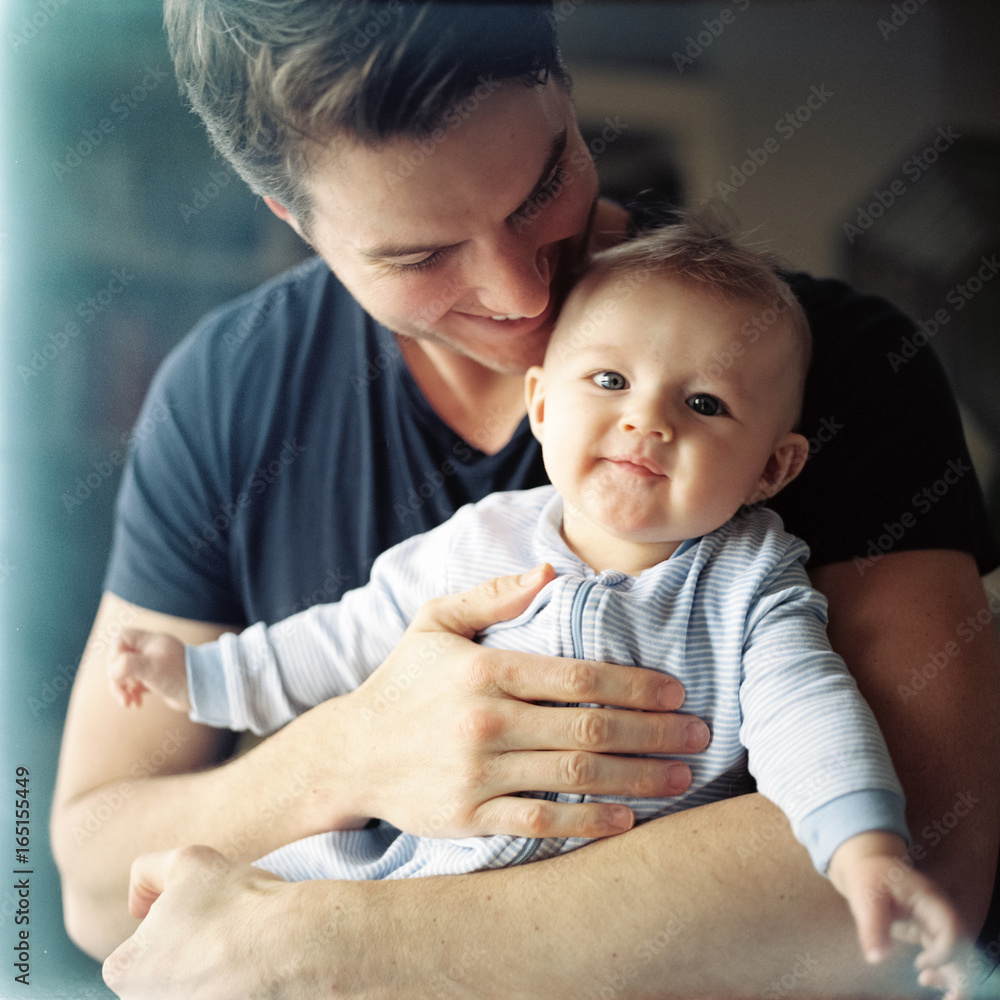 Happy father holding baby son in his arms Stock Photo | Adobe Stock