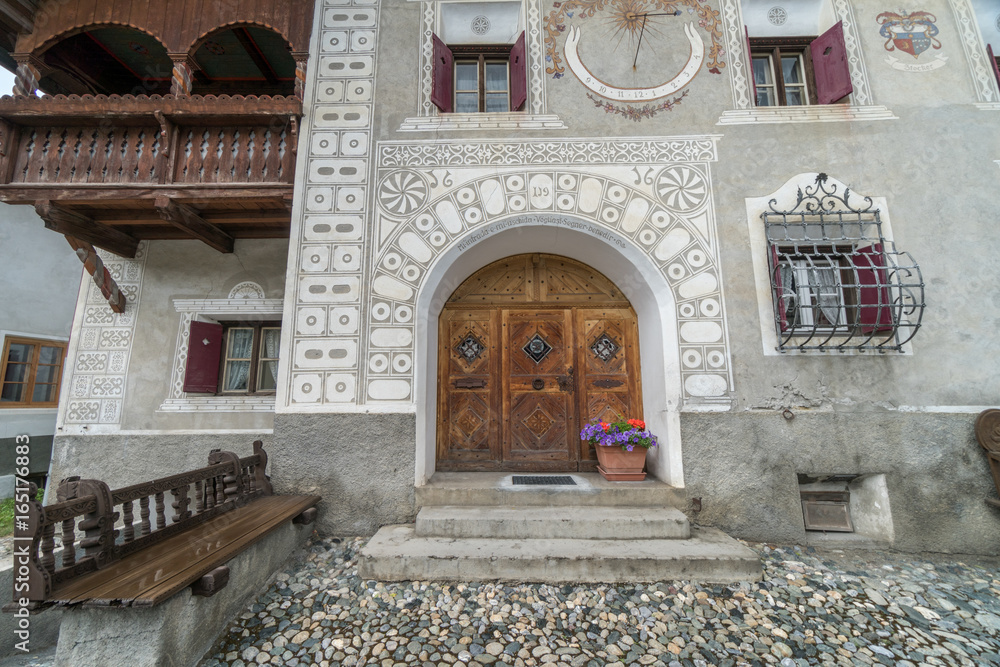 entrance and house front of a typical Engadin house with traditional ...