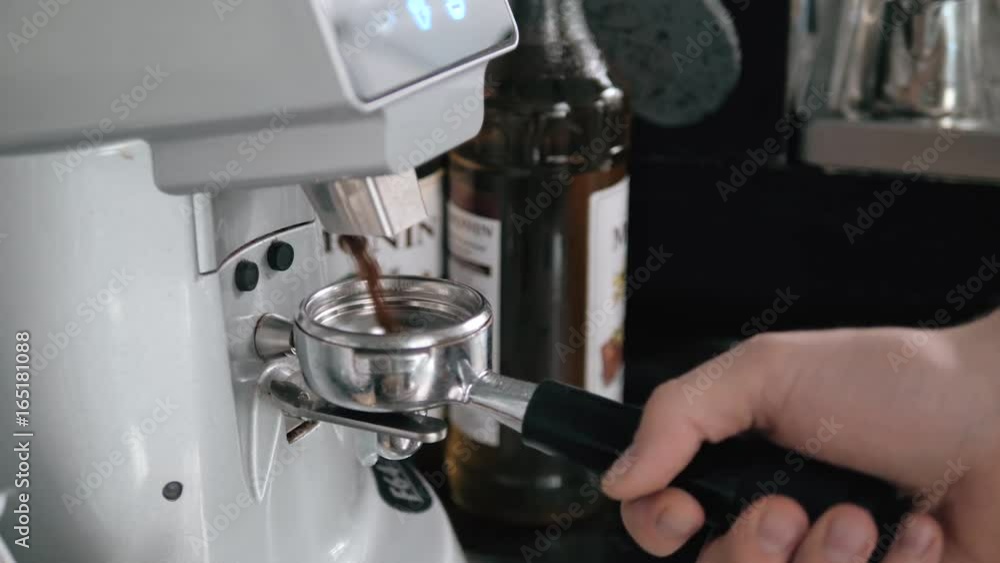 Prepares espresso in his coffee shop; close-up counter espresso ...