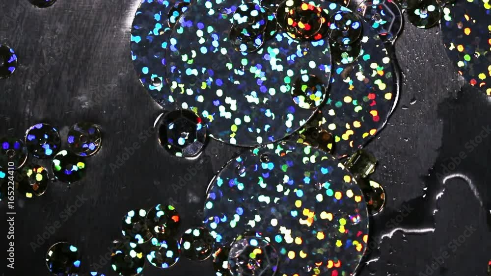 Abstract video clip. Multicolor sequins movie down, glowing paillette ...