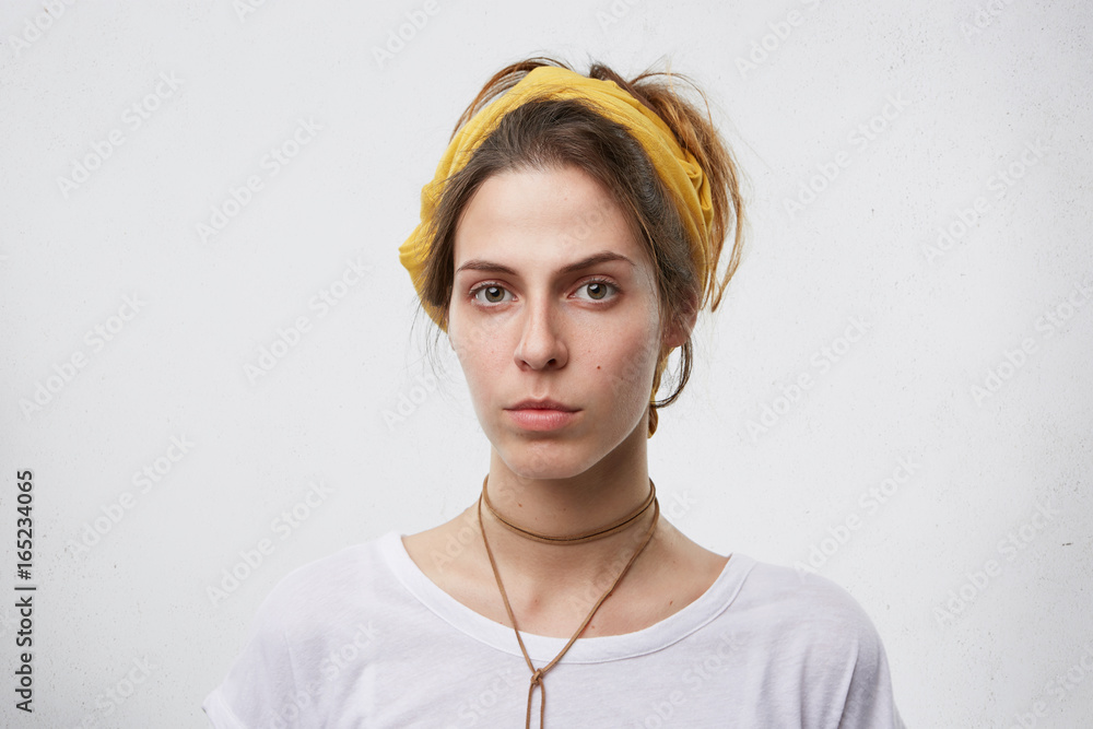 Portrait of beautiful serious female with European appearance dressed ...