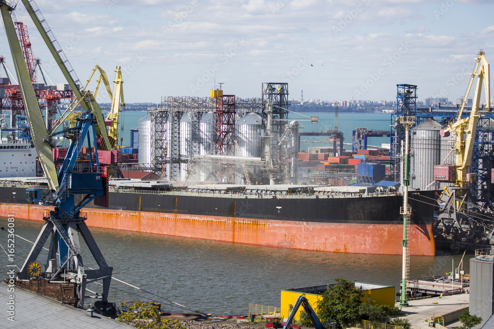 Ship dry cargo in port for loading grain. Vessel bulk carrier loading ...