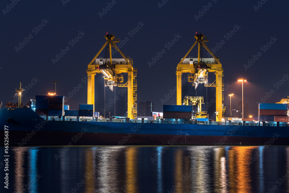 container cargo freight ship with working crane bridge in shipyard at ...