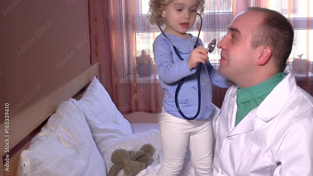 Cute little patient boy playing with his doctor stethoscope in hospital ...