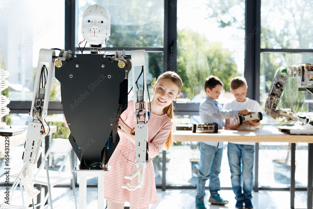Charming girl posing behind a human robot back Stock Photo | Adobe Stock