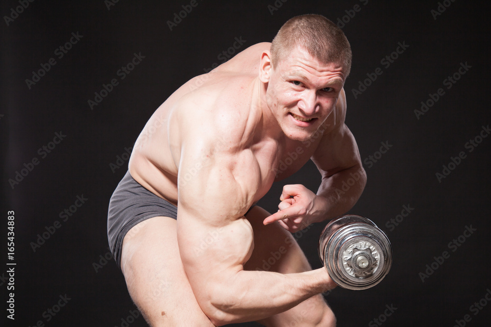 Sport the athlete bodybuilder build muscles dumbbells Stock Photo ...