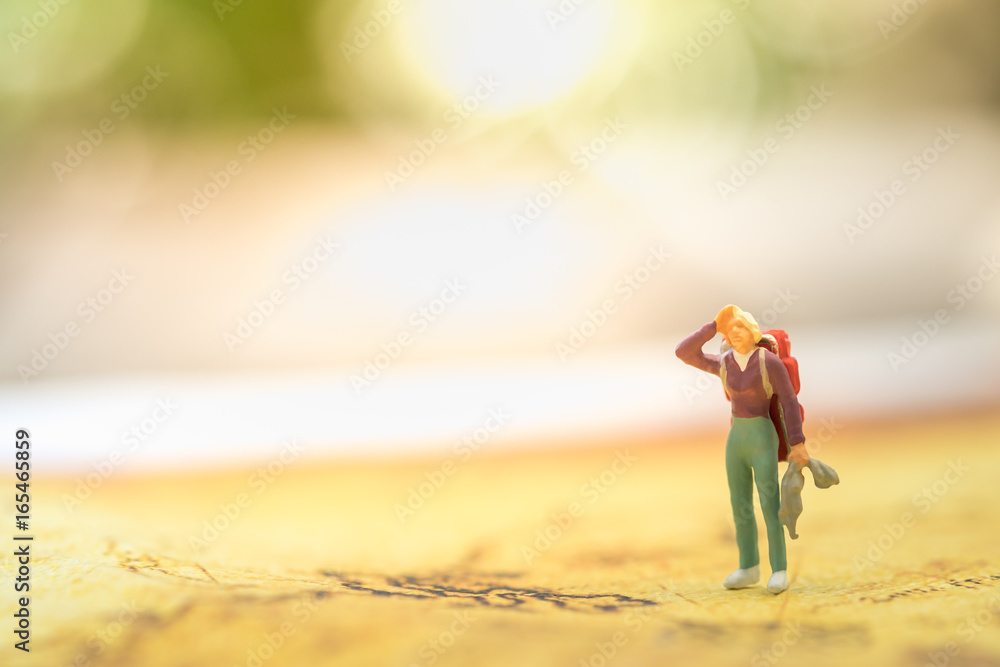 Travel Concept. Female traveler miniature figure with backpack standing ...