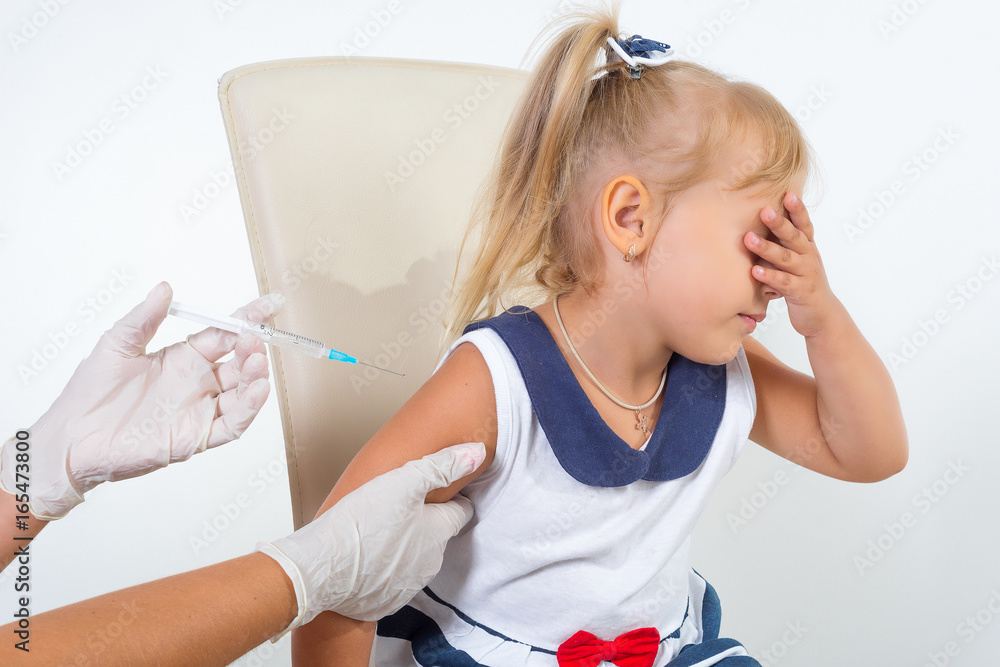 Doctor holds syringe to vaccinate sick baby with injection. Crying and ...