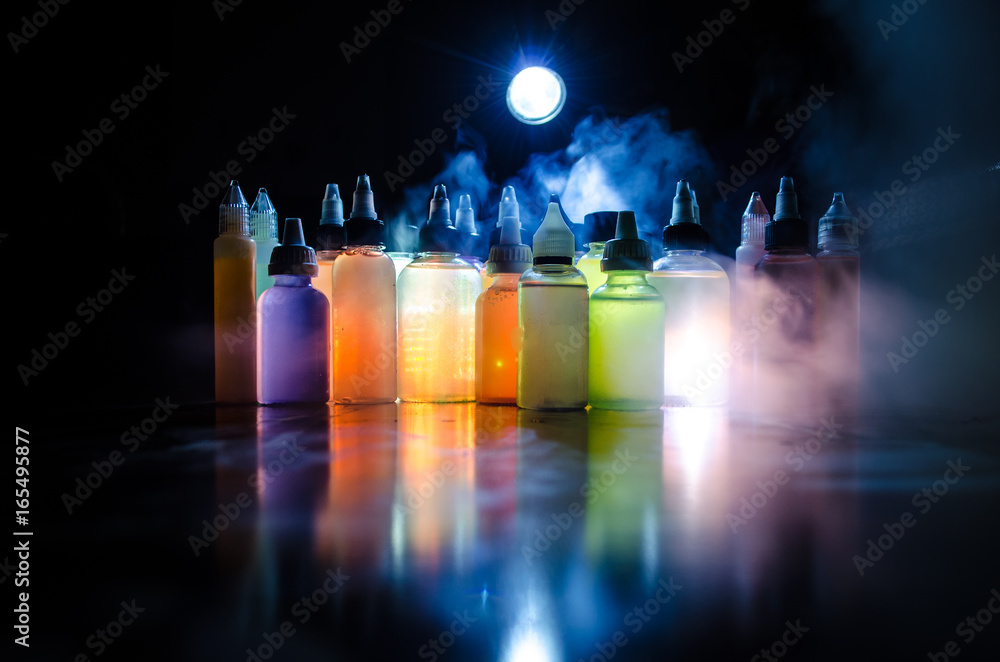 Vape concept. Smoke clouds and vape liquid bottles on dark background ...