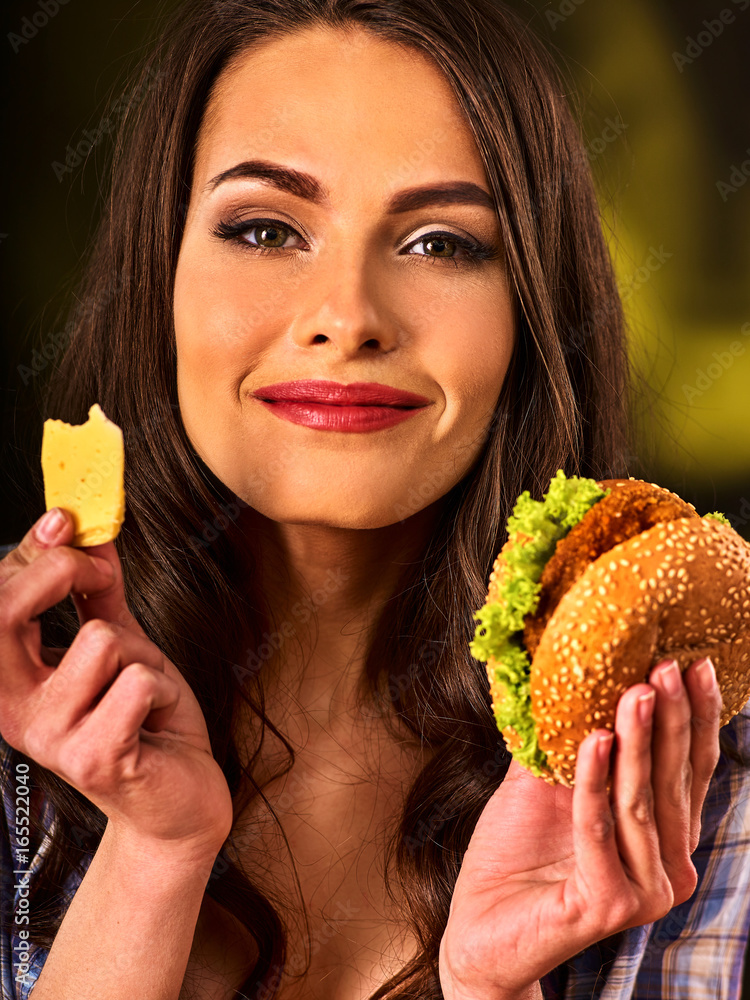 Woman eating hamburger. Portrait of student consume fast food . Girl ...