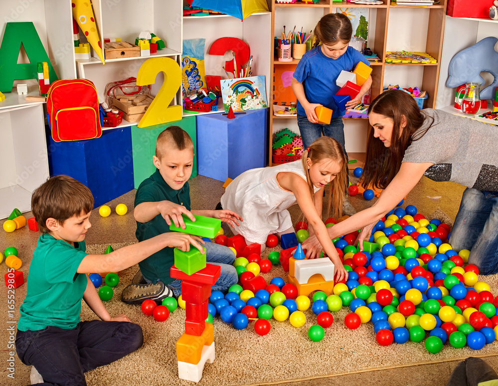 Children playing in kids cubes indoor. Lesson in primary school. Body ...