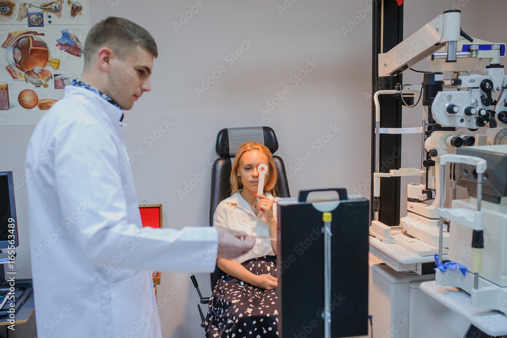 In an ophthalmologic clinic dooing a visual test for young patient ...