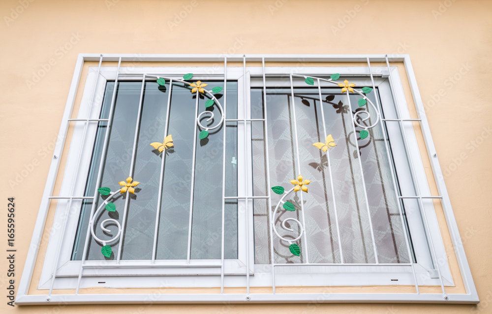 Pattern of curved steel (wrought iron) on a glass window. Stock Photo ...
