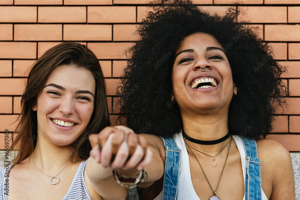 Beautiful women having fun in the street. Stock Photo | Adobe Stock
