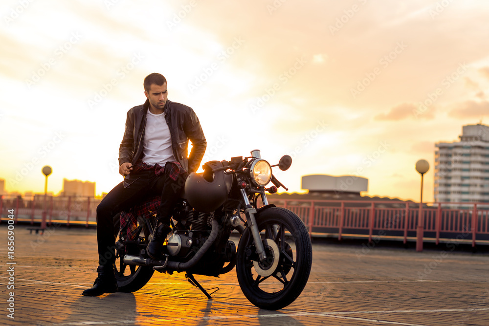 Handsome rider guy with beard and mustache in black leather biker ...