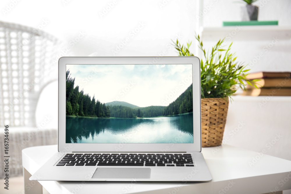 Workplace with laptop and wallpaper of landscape on screen Stock Photo ...