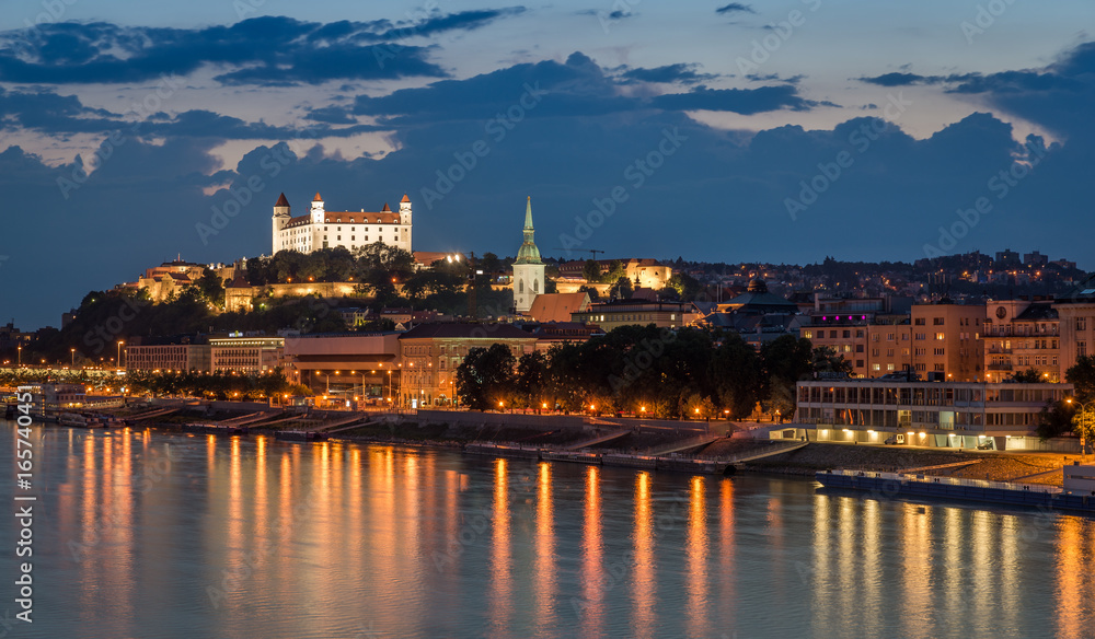 Bratislava castle at night with light reflection on the dunaj river on ...