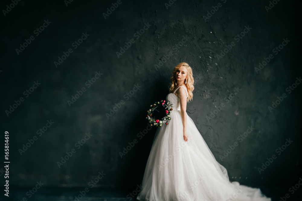 Young beautiful happy glamorous bride in white expensive stylish weding ...