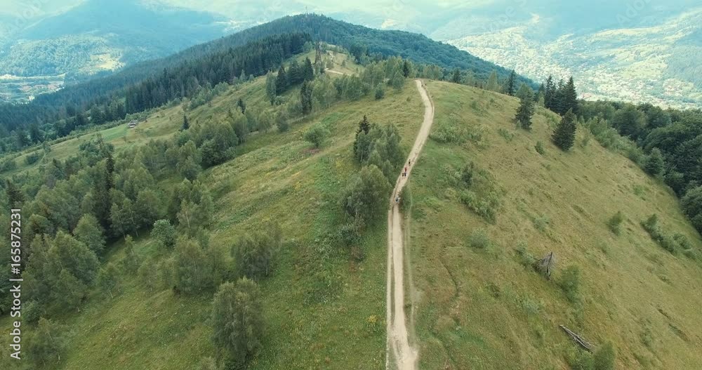 Aerial view of country road over hill in mountain Stock Video | Adobe Stock