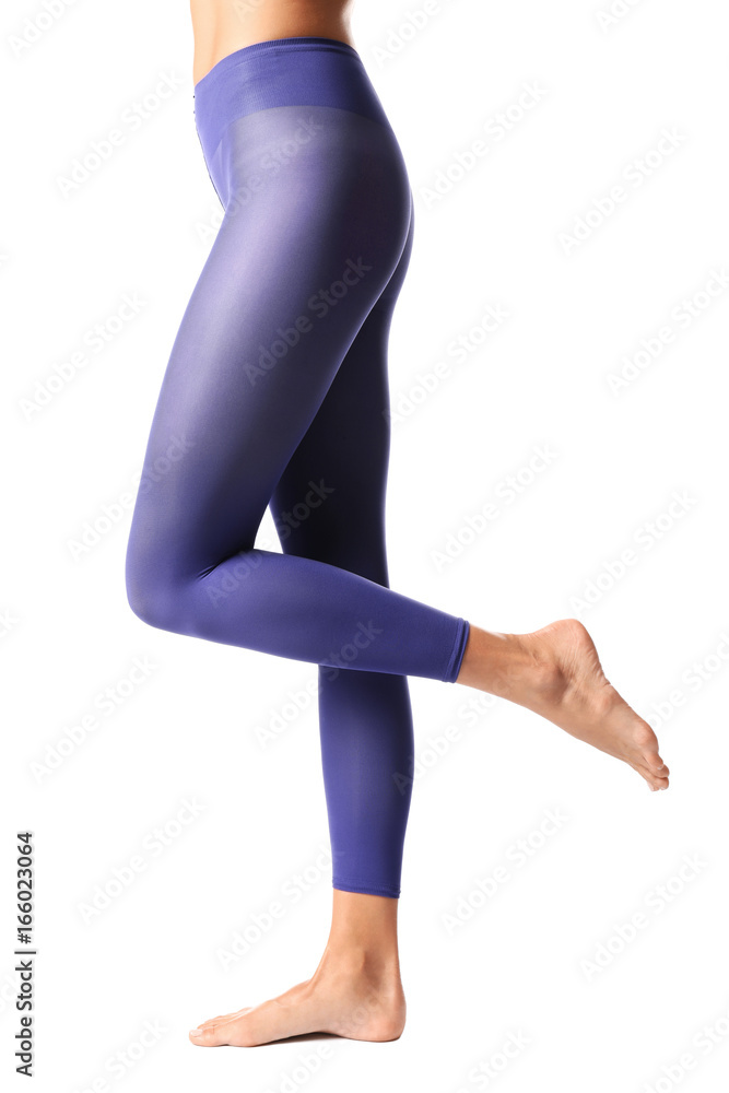 Legs of beautiful young woman in footless tights on white background ...