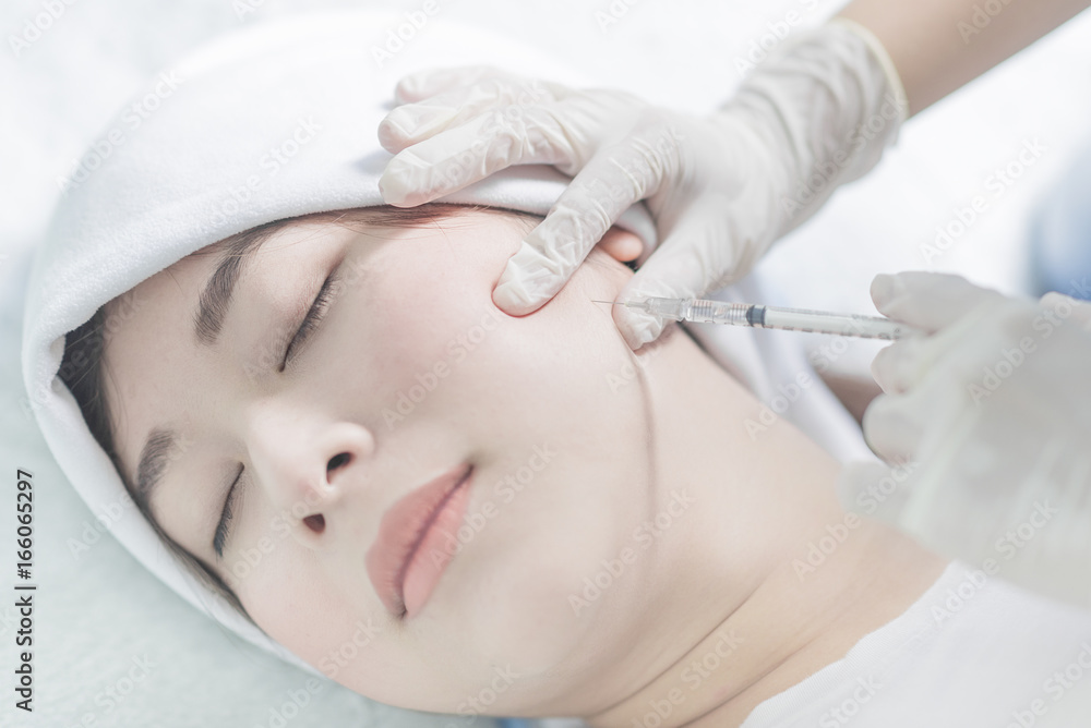Botox injection on the cheek to change the face shape. #166065297 ...