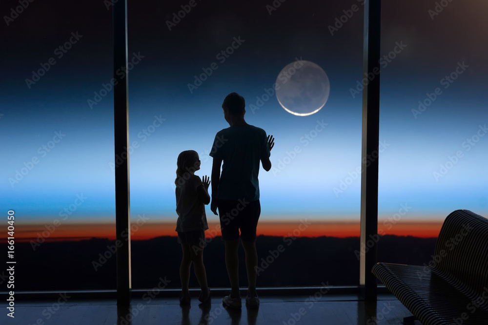 Children look at the moon through the window Stock Photo | Adobe Stock
