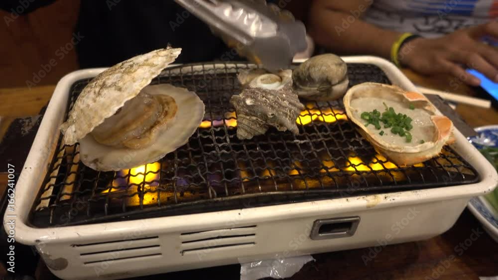 Japanese seafood barbecue , sea shell and clam shell BBQ grilled on ...