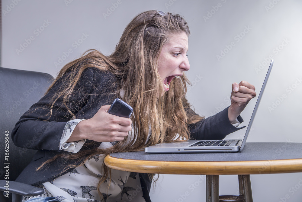 Angry furious business woman yelling at her laptop in her office Stock ...
