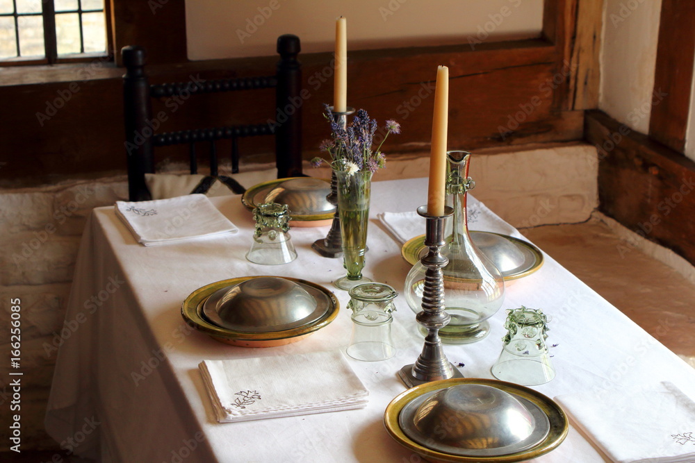 Pretty tudor dining table in a middle class medieval home, set with ...