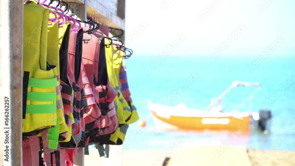 Watersport adventure background video - colorful life vests on a beach ...
