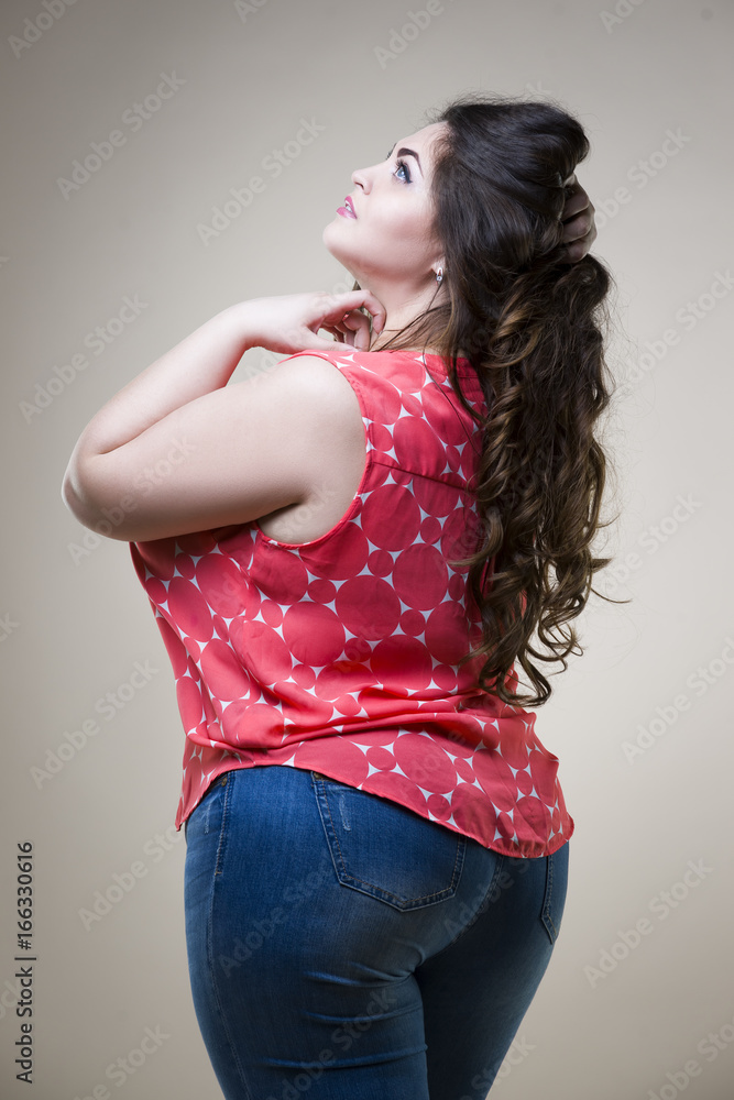Plus size fashion model in casual clothes, fat woman on beige studio ...