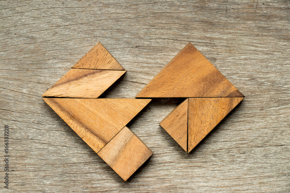 Wooden tangram puzzle in separate heart shape background (Concept for ...