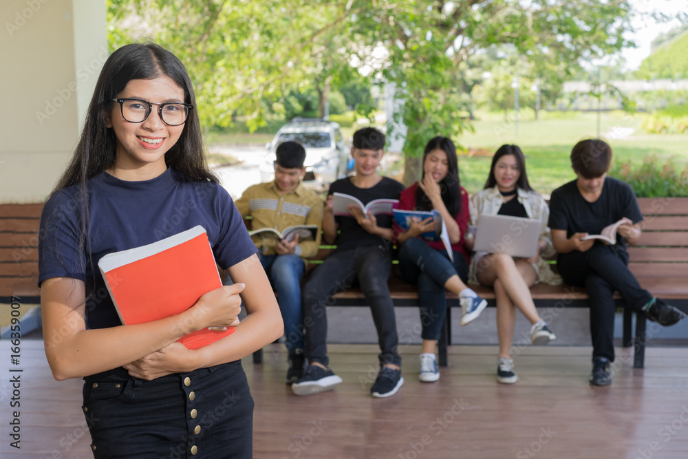Education first, Beautiful female college student holding her books ...